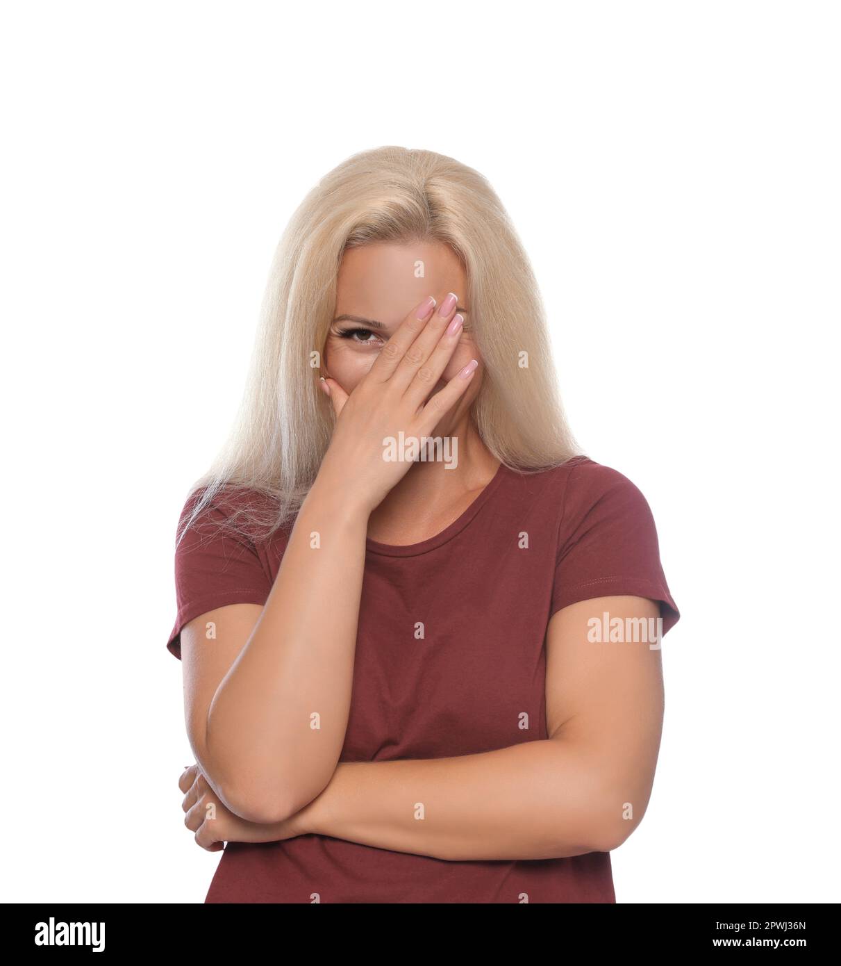 Embarrassed woman covering face with hand on white background Stock ...
