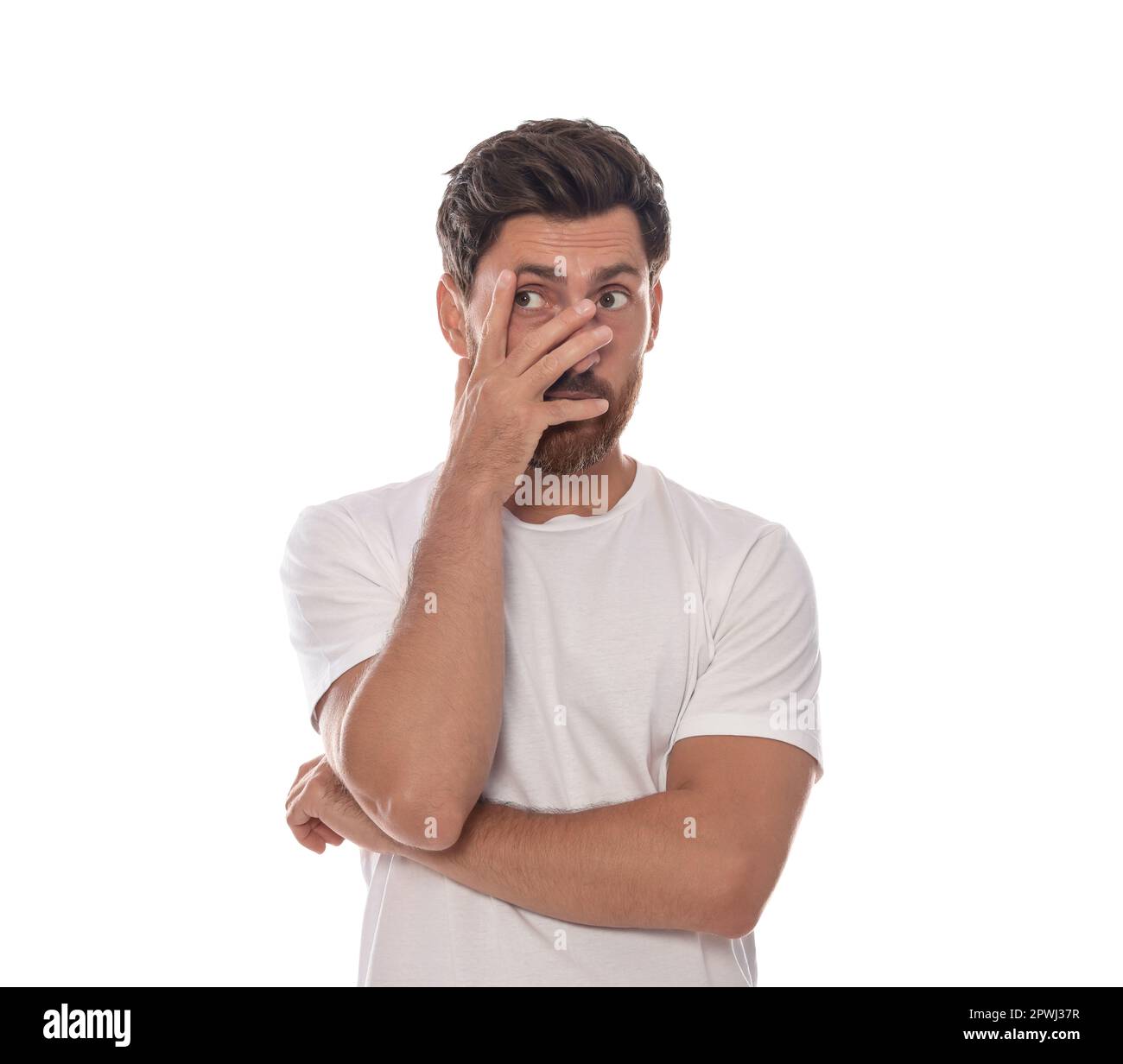 Embarrassed man covering face with hand on white background Stock Photo - Alamy