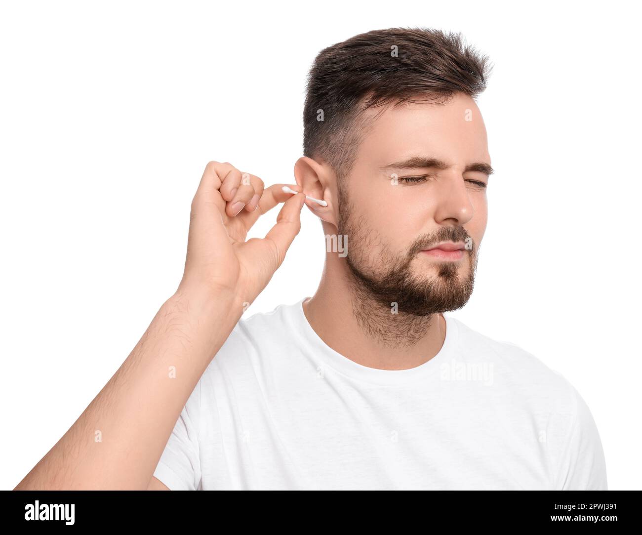 Young man cleaning ear with cotton swab on white background Stock Photo ...