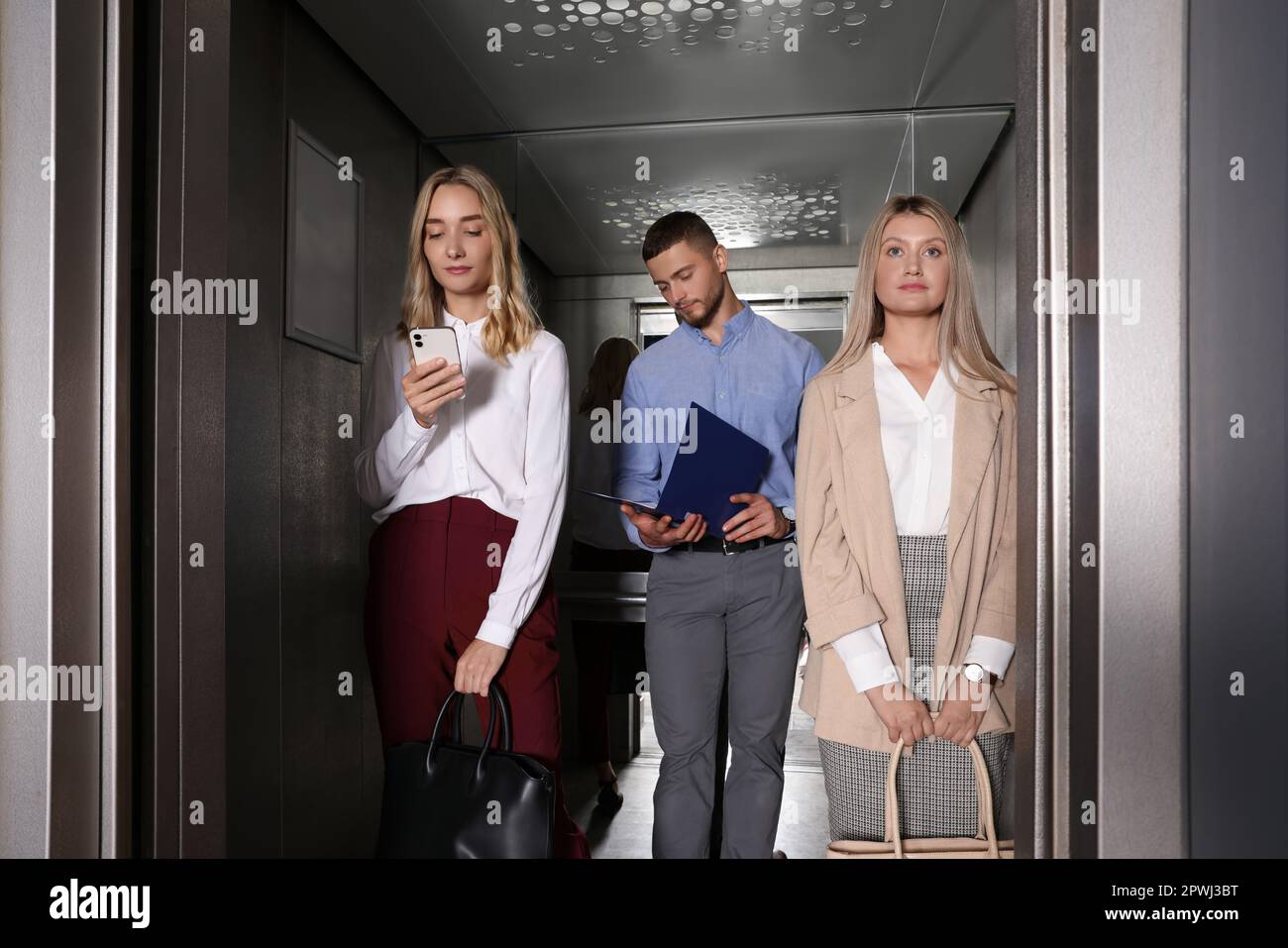 Group of office workers in modern elevator Stock Photo - Alamy