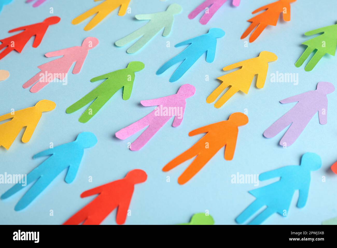 Many different paper human figures on light blue background. Diversity ... Many different paper human figures on light blue background. Diversity ...