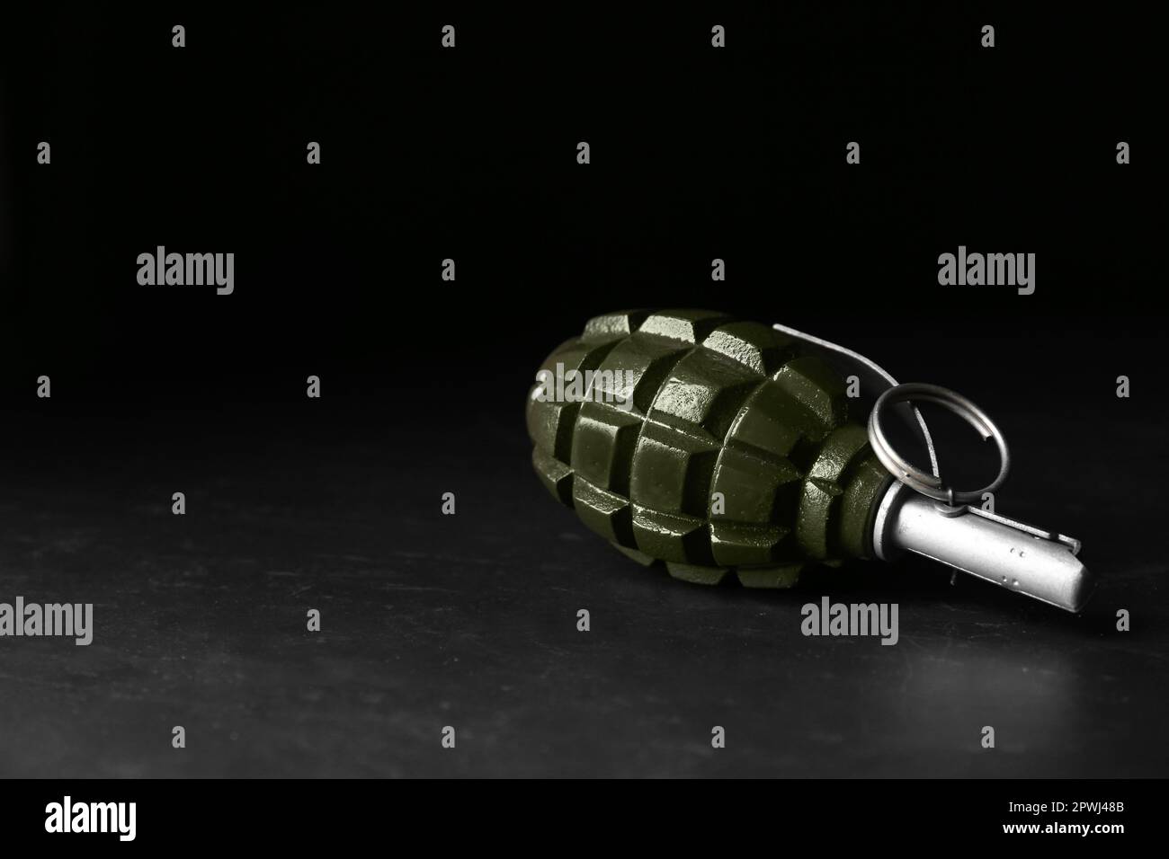 Hand grenade on black background. Space for text Stock Photo - Alamy