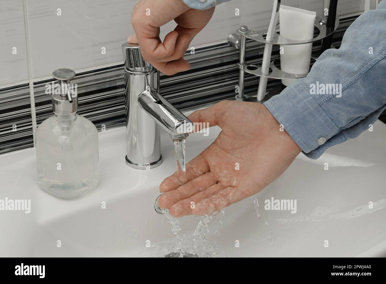 Person rinsing hands in bathroom hi-res stock photography and images ...