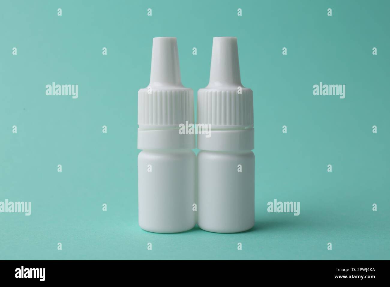 Bottles of medical drops on turquoise background Stock Photo - Alamy