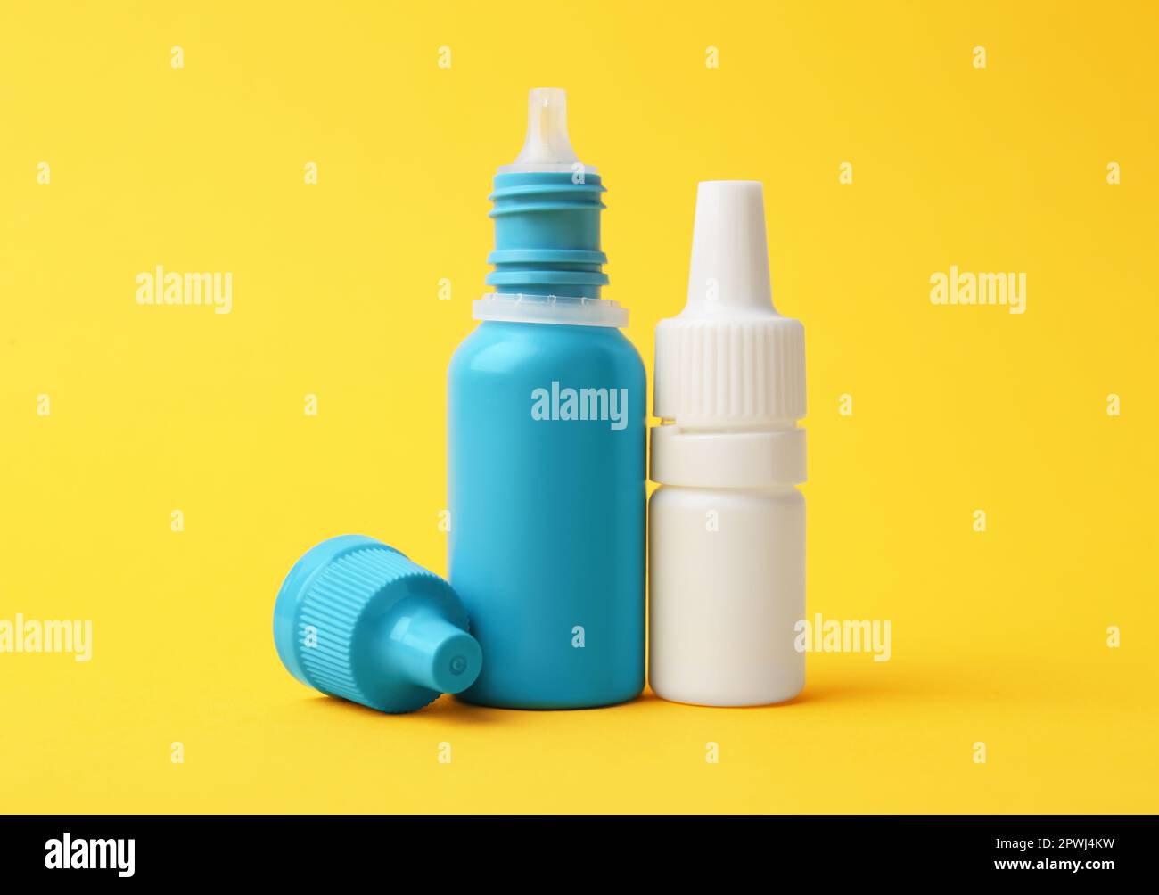 Bottles of medical drops on yellow background Stock Photo - Alamy