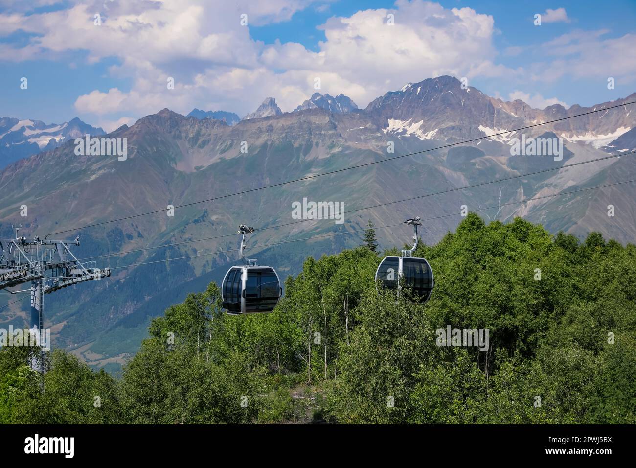 View of cableway with modern cabins in mountains Stock Photo - Alamy