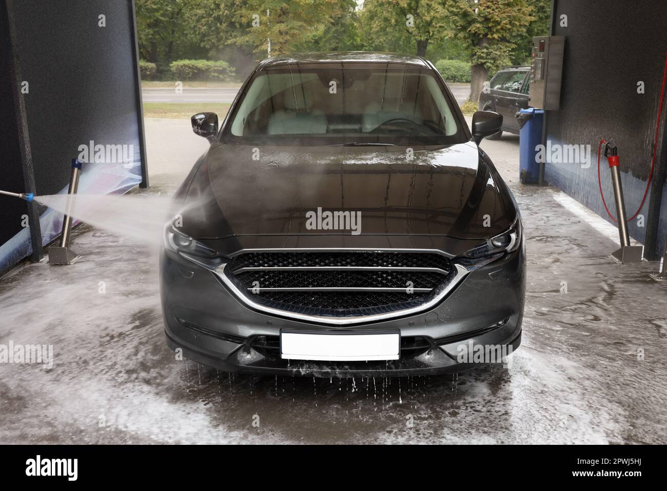 Washing auto with high pressure water jet at outdoor car wash Stock ...