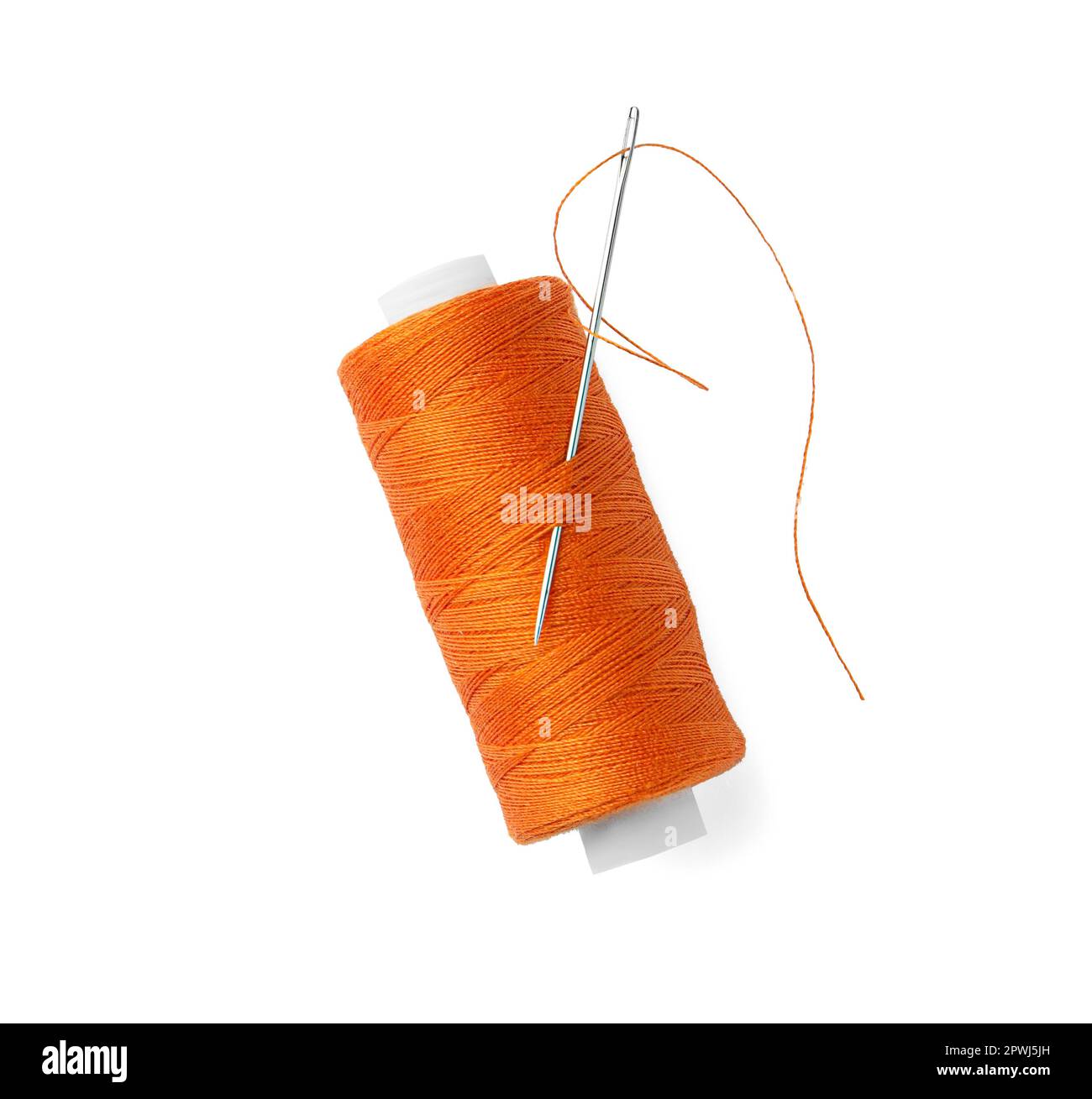 Spool of orange sewing thread with needle isolated on white, top view ...
