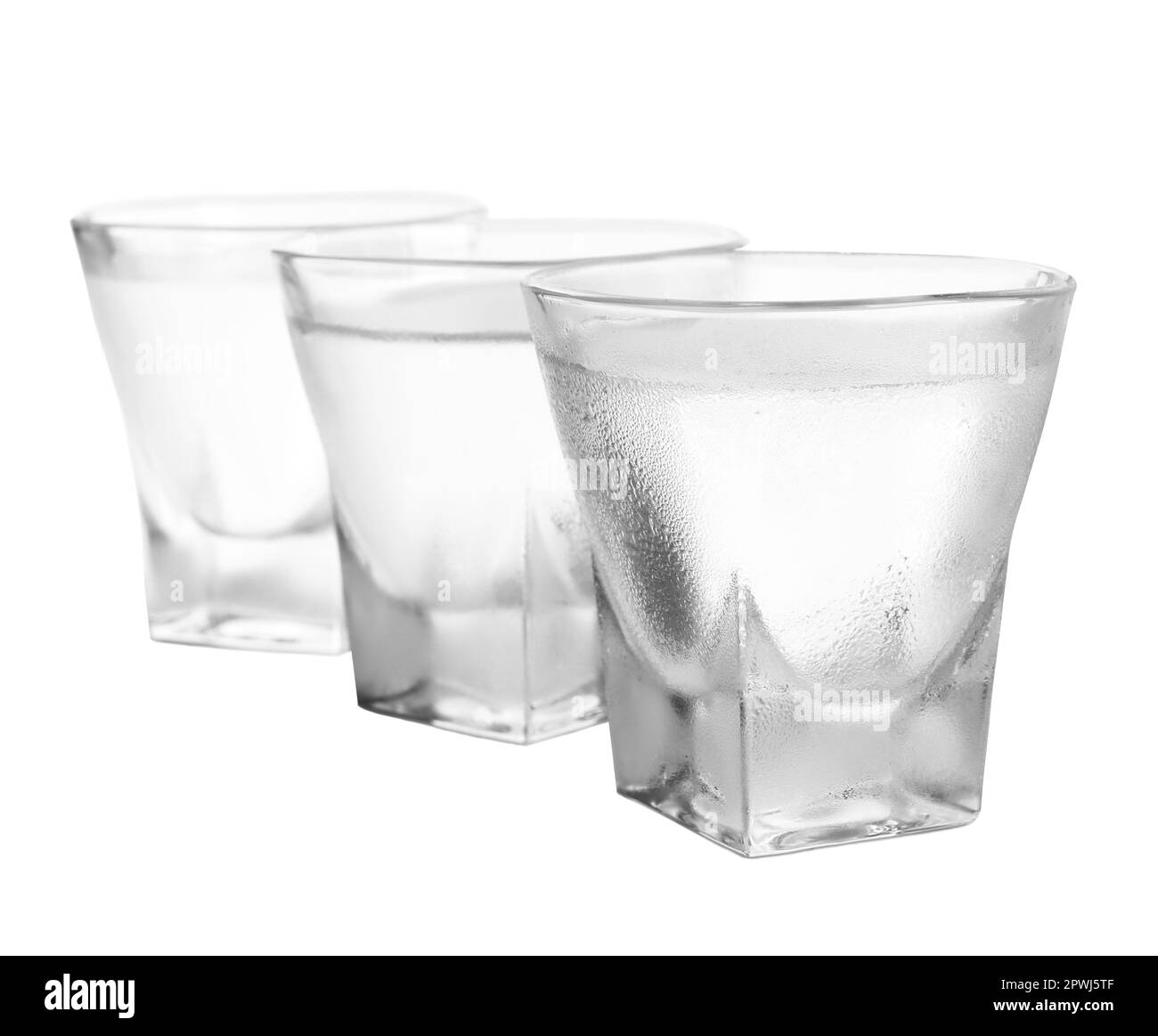 Vodka in shot glasses on white background Stock Photo - Alamy