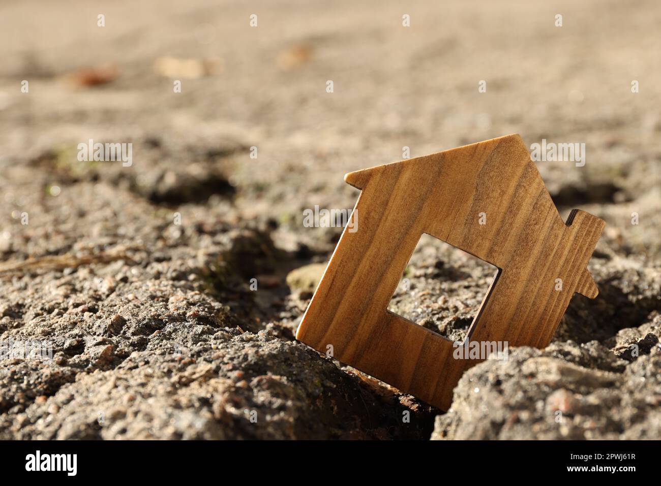 Wooden house model in cracked asphalt. Earthquake disaster Stock Photo ...