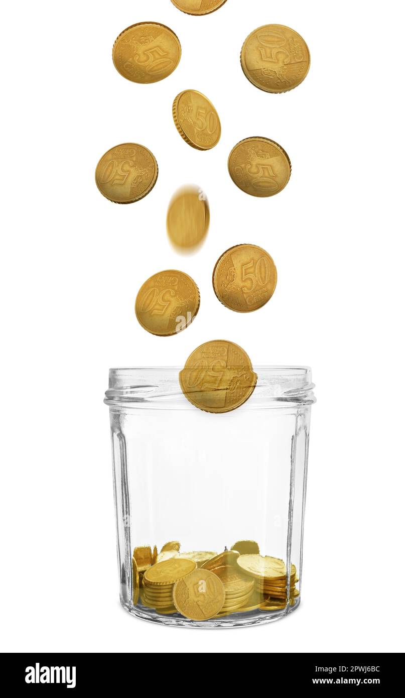 Coins falling into glass jar on white background Stock Photo - Alamy