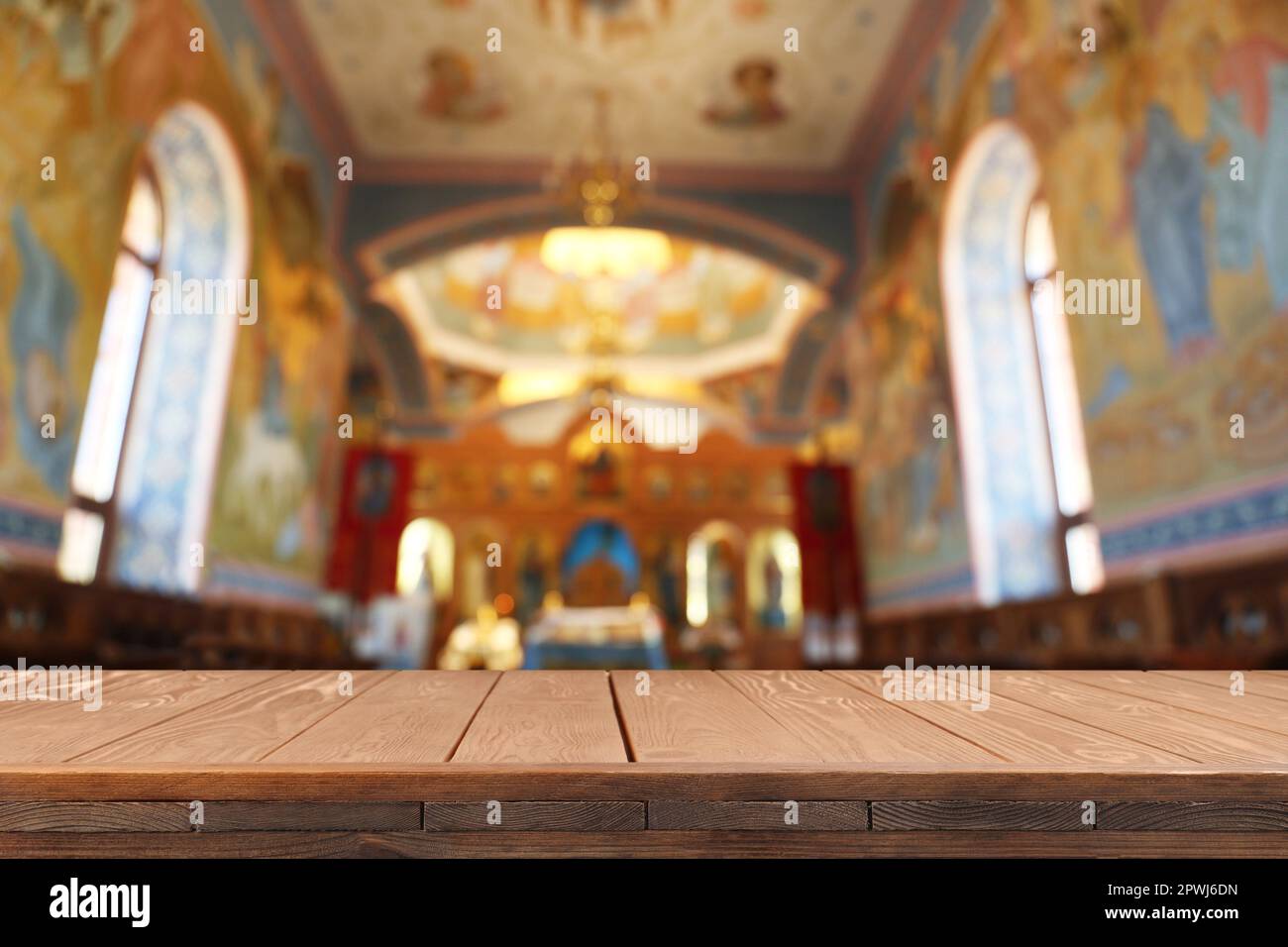 Empty wooden table and blurred view of beautiful church interior, space ...