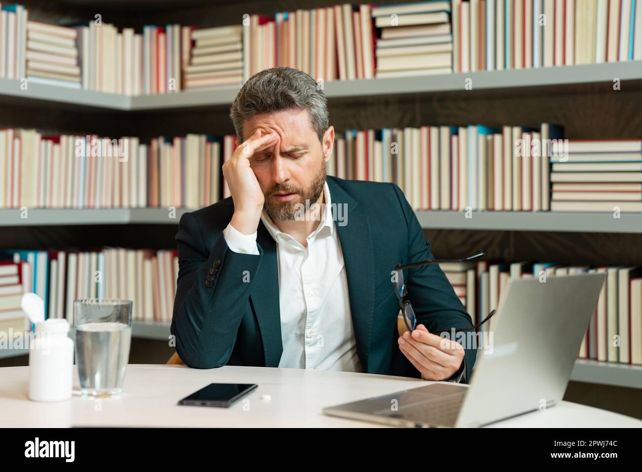 Business man feel pain holding glasses rubbing dry irritated eyes ...