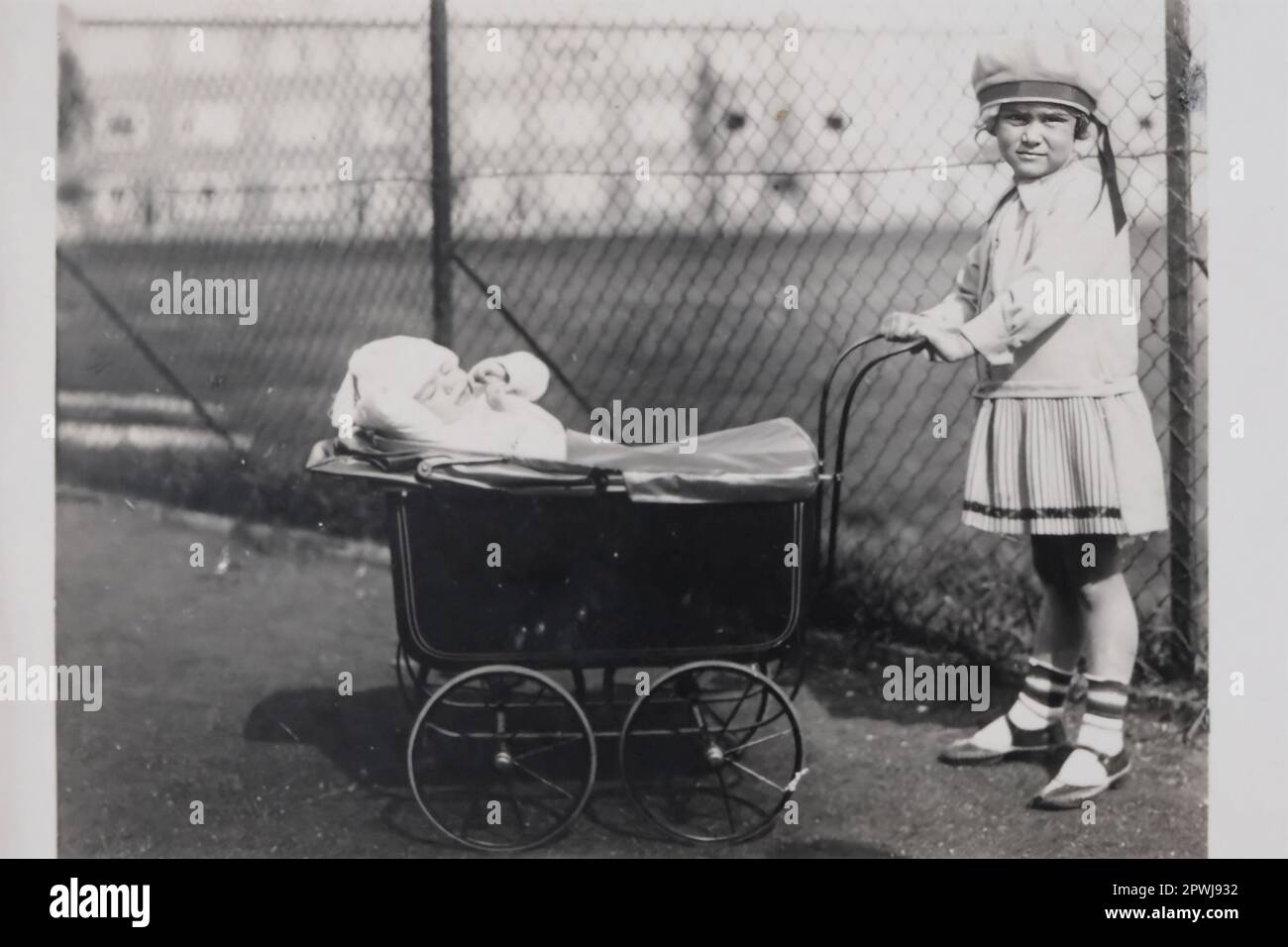 Little girl pushes stroller with baby brother in 1927 Stock Photo - Alamy