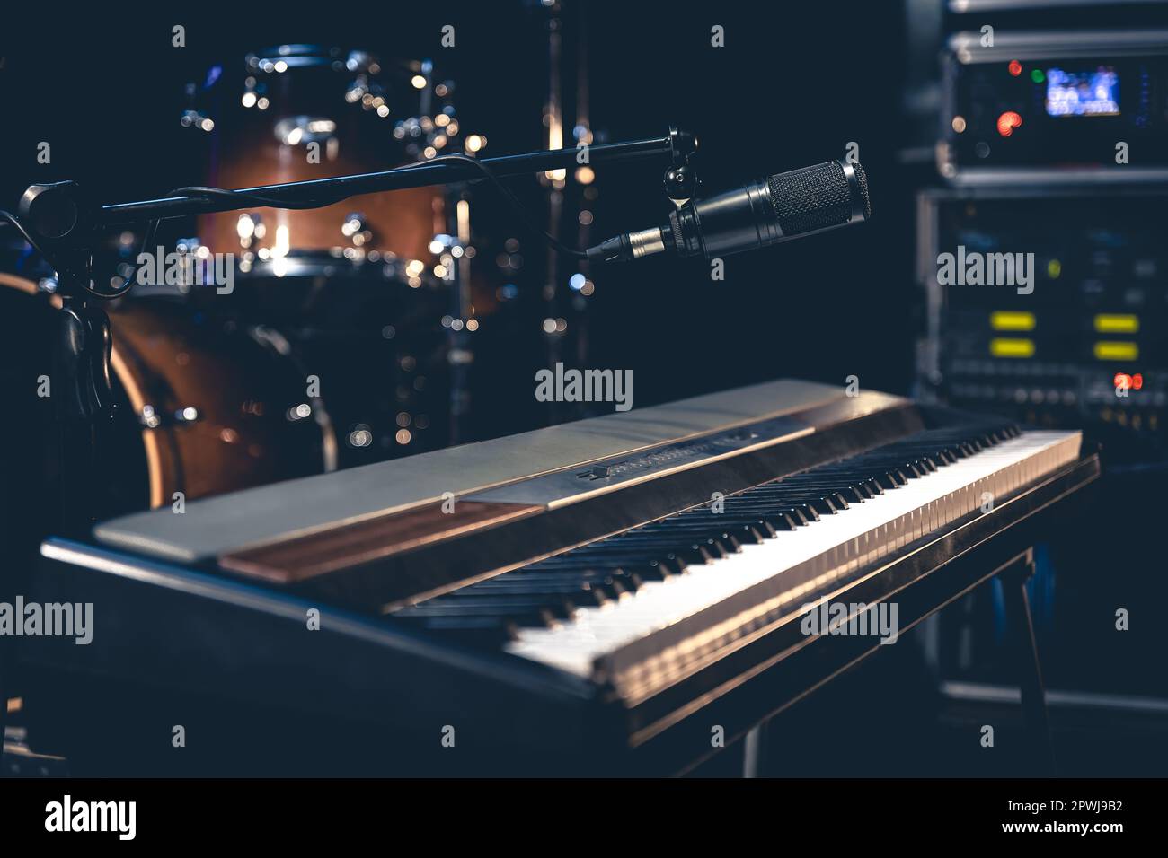 Piano and and microphone on a dark background in the interior of a ...