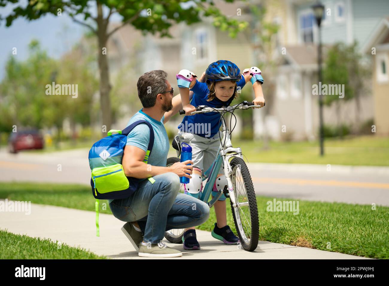 Fathers day. Father teaching son ride a bicycle. Father and son cycling ...