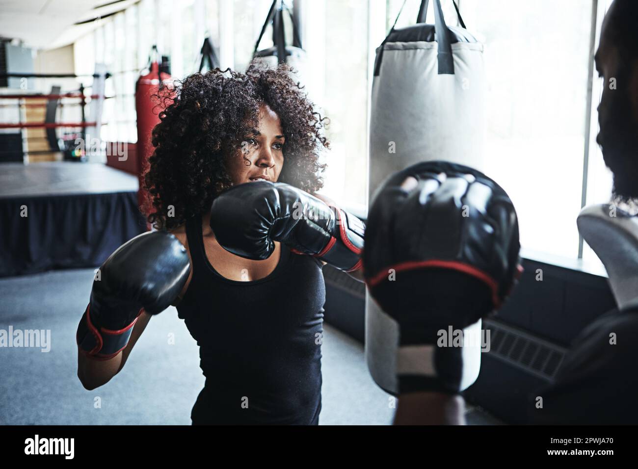 Every move you make starts with your heart. a female boxer practising ...