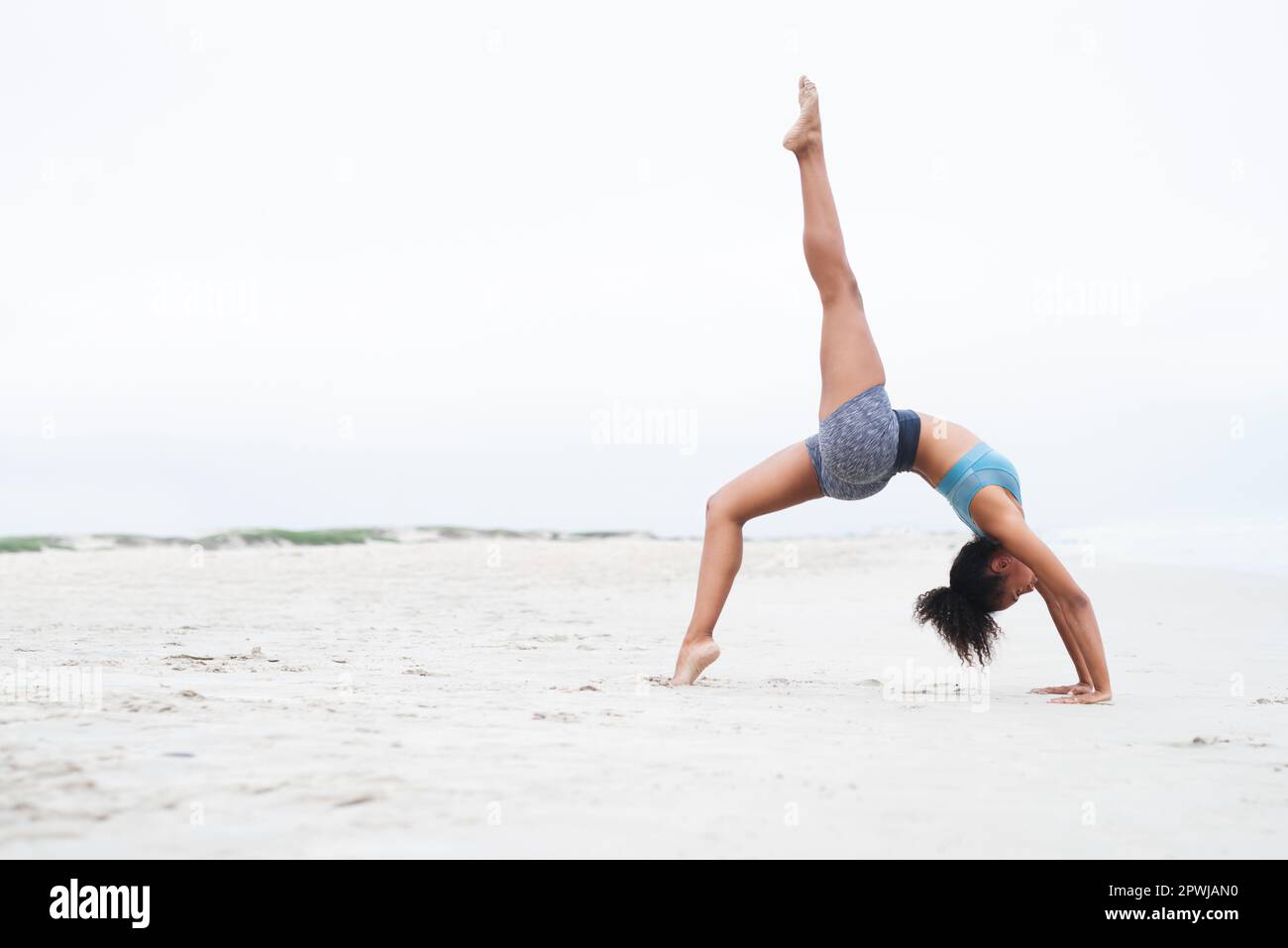 Woman doing handstand beach hi-res stock photography and images - Alamy