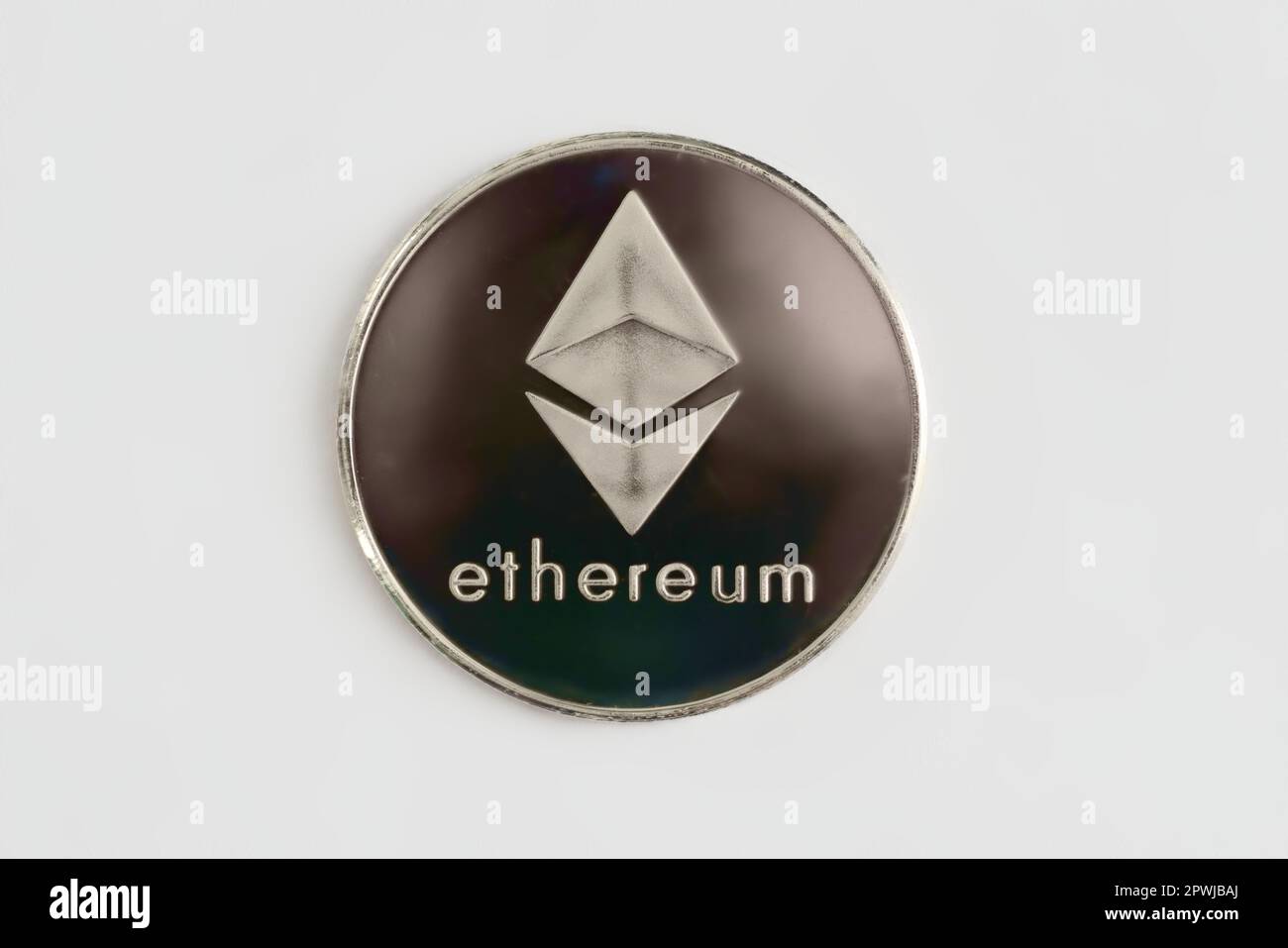 Silver physical Ethereum coin on white background. Digital currency ...