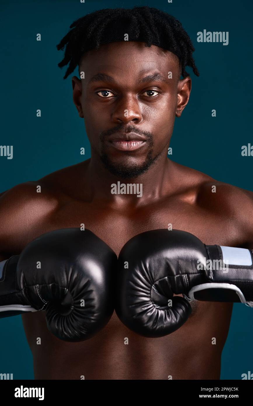 Challenge accepted. Cropped portrait of a handsome young boxer working ...