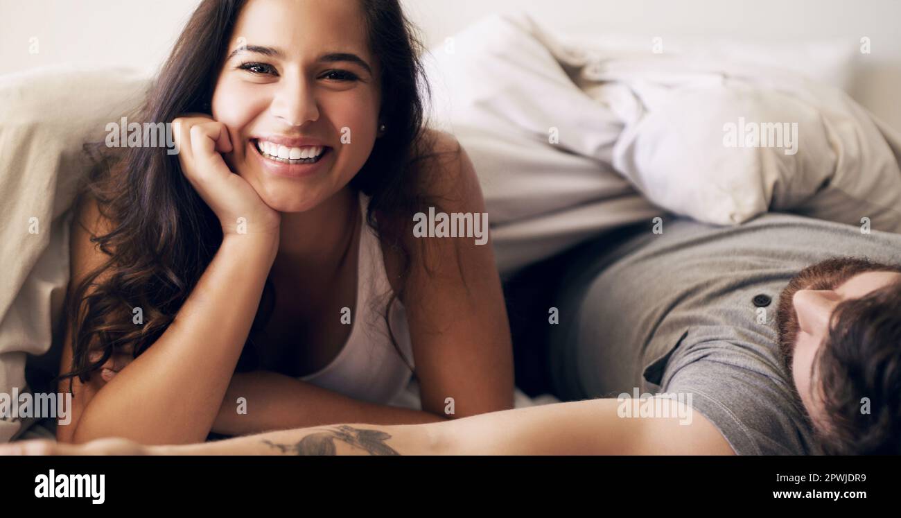 Make time to spend time. a happy young couple relaxing in bed together ...