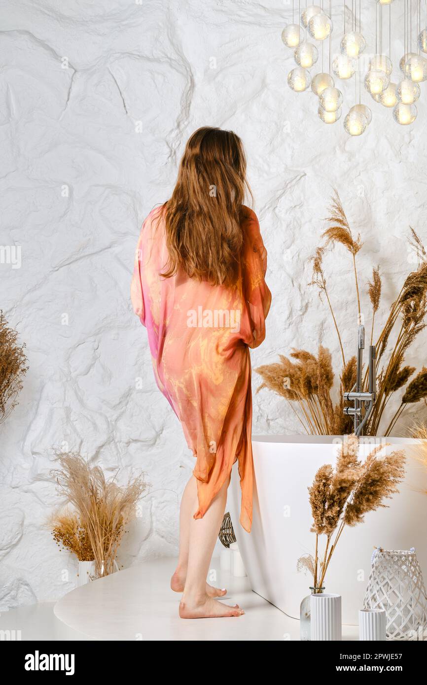 Unrecognizable woman preparing a bath in a spa, back view Stock Photo ...