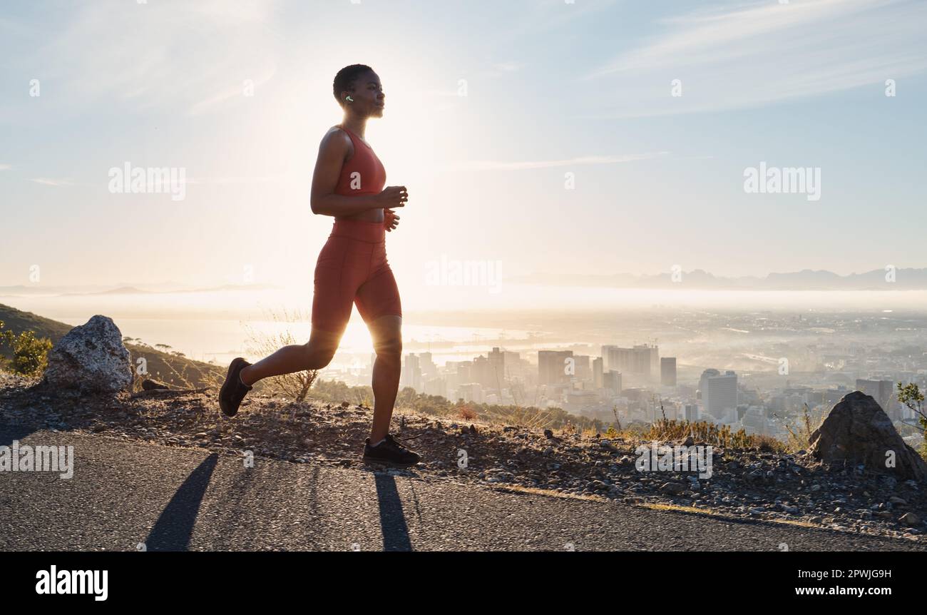 Black woman, runner and fitness with music on mountain for sports ...