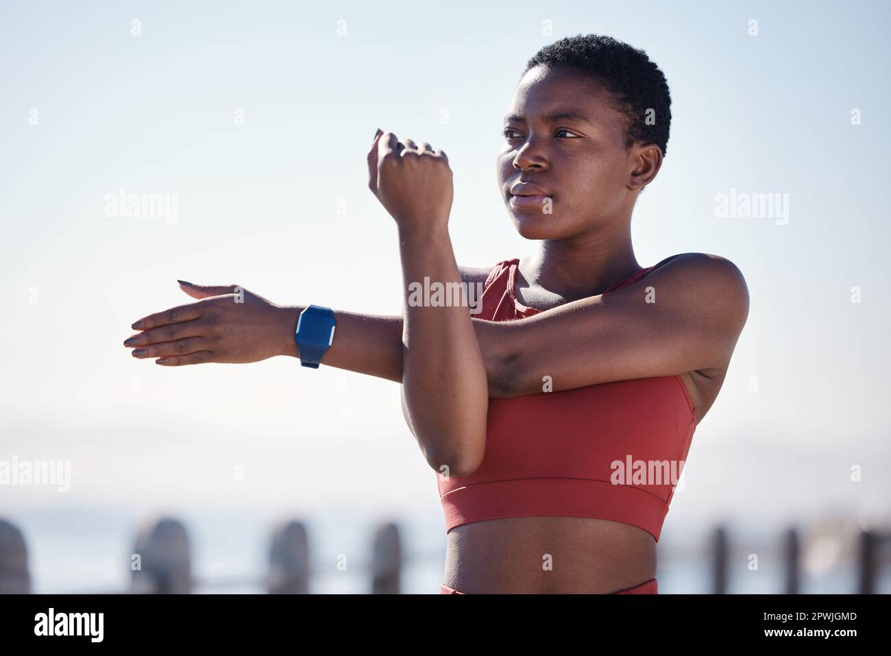 Black woman, fitness and stretching arms for exercise, workout or cardio training in the ...