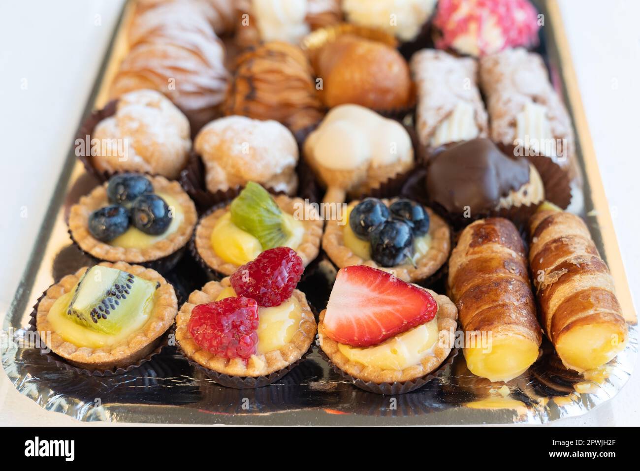 Assortment of delicious and colorful pastries, made by pastry chef. All ...