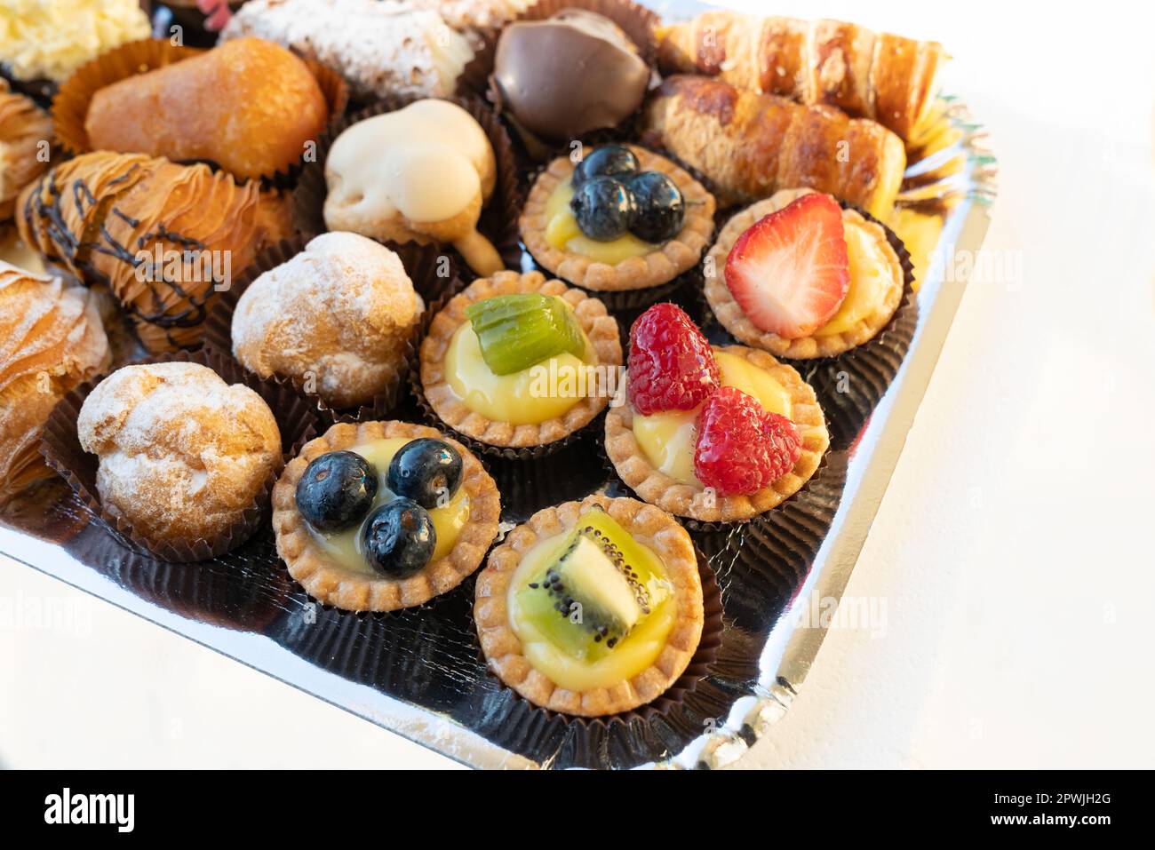 Assortment of delicious and colorful pastries, made by pastry chef. All ...