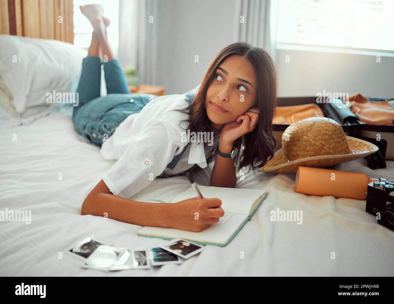 Bed, woman thinking and writing in notebook for travel vacation ...