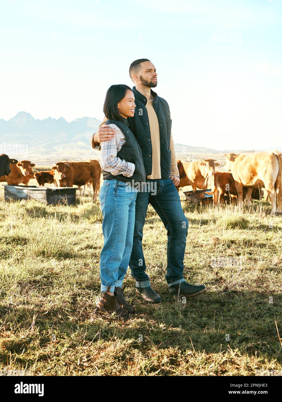 Couple, farm and hug in countryside travel, trip or holiday destination ...