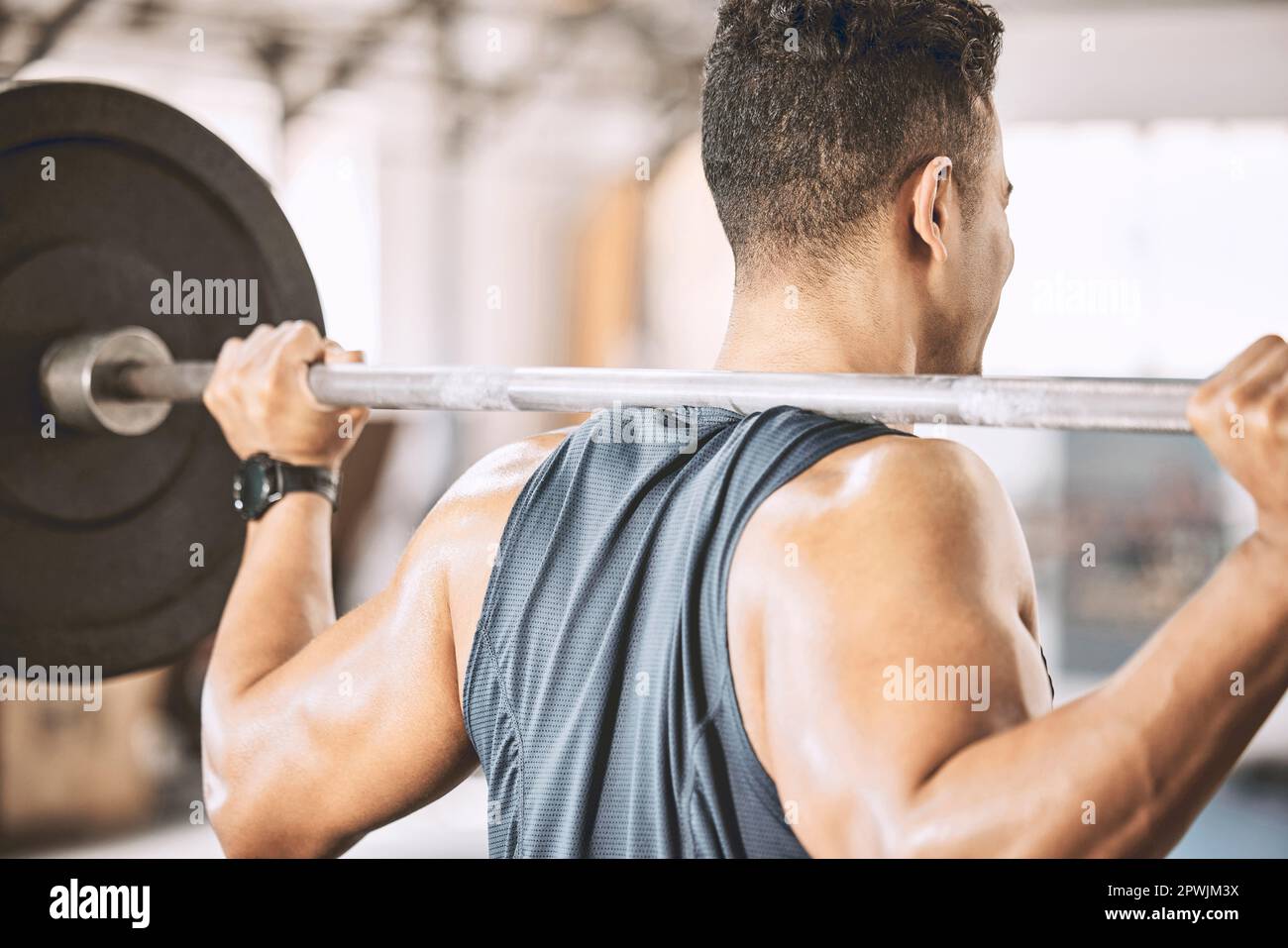 Back of bodybuilder lifting heavy weight. Strong bodybuilder building ...
