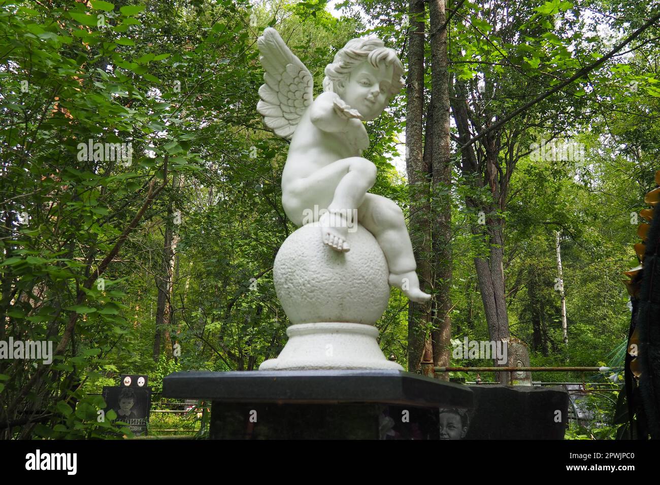 Angel in the cemetery monument at the grave of a child sculpture in the ...