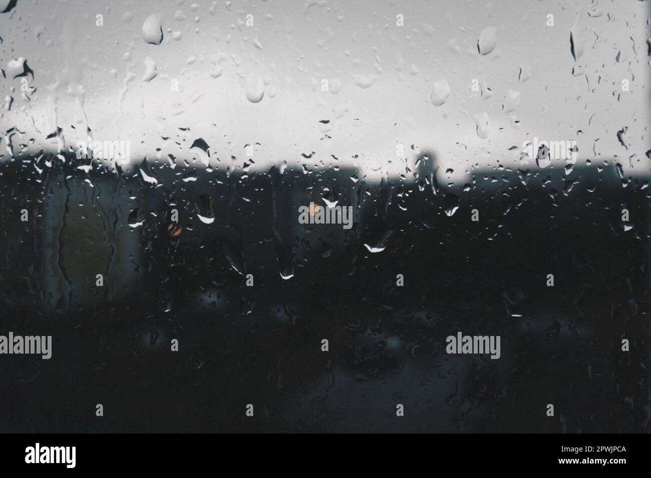 bad weather in the city. Buildings, houses, cars outside the window ...