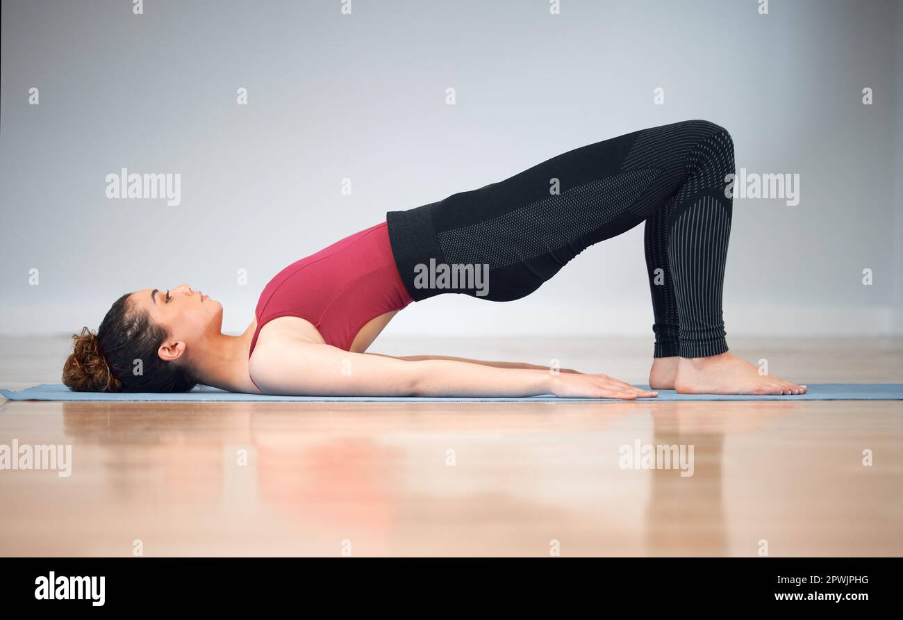 Stabilise yourself using your legs. a young woman completing bridge ...