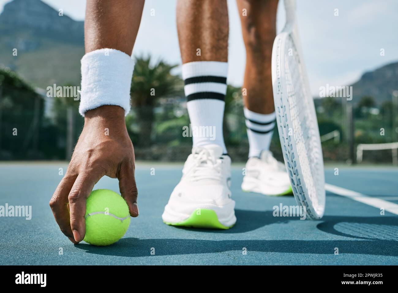 Leave it on the court. an unrecognizable man bending down to pick up a ...