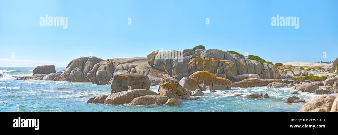 Outdoor ocean landscape of calm water and big rocks in the sea ...