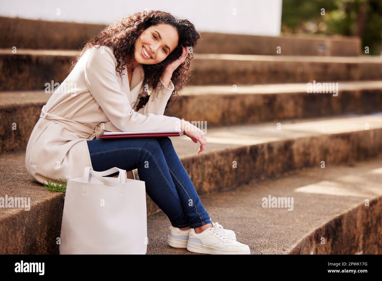 Just chilling between classes. Portrait of an attractive young female ...