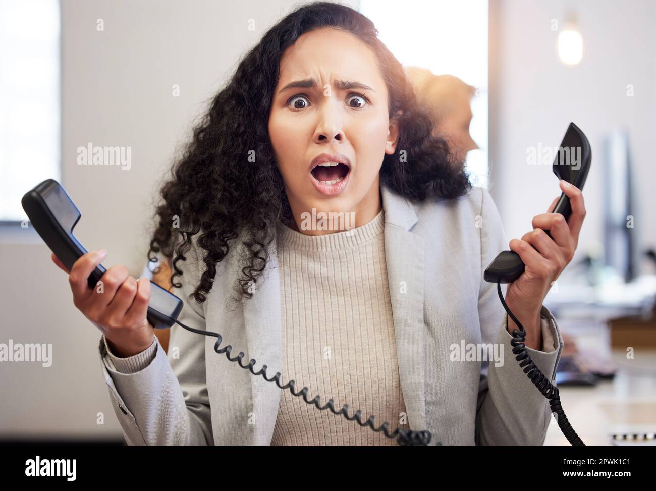 The phones been ringing off the hook. a young businesswoman looking ...