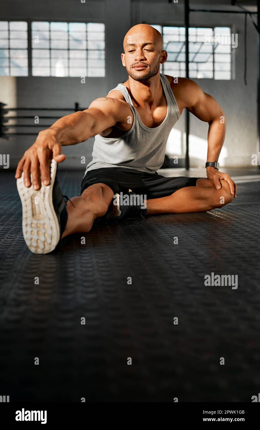 Stiff muscles are easily avoided. a young man stretching his legs ...