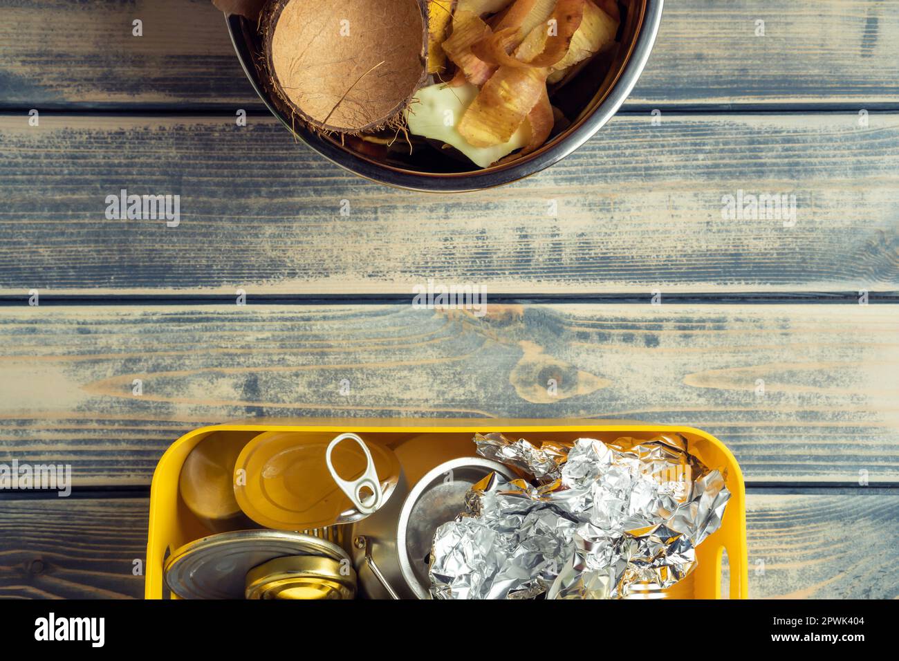 Two halves of containers with organic food and metal foil waste, trash ...