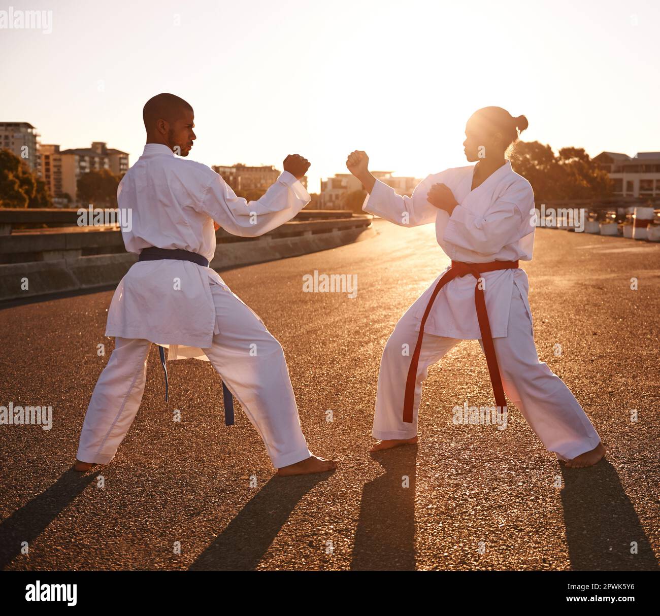 Lets go...Two sportspeople facing off and practicing their karate while ...