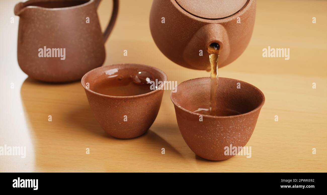 Traditional Chinese tea ceremony, pour tea into a cup Stock Photo - Alamy