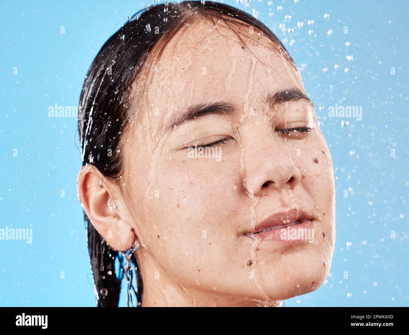 Relax, water and face of a woman in the shower for cleaning, peace and ...