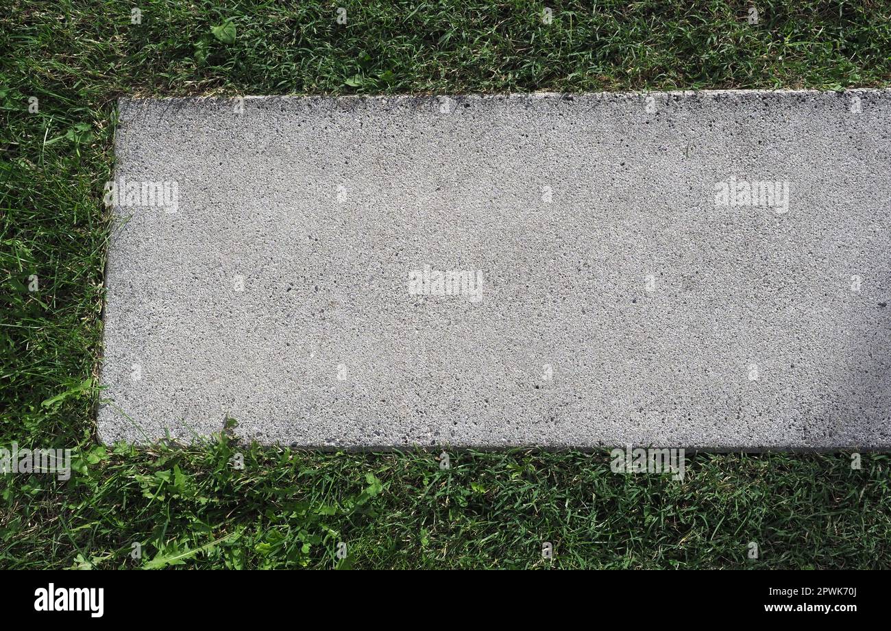 grey concrete tiles path in the grass Stock Photo - Alamy