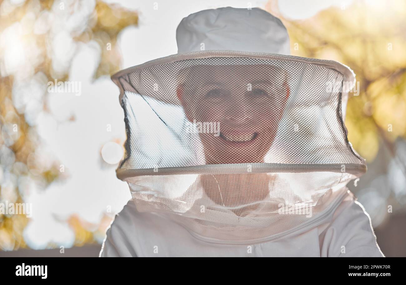 Beekeeper, woman and protective suit in portrait, happy and outddor ...