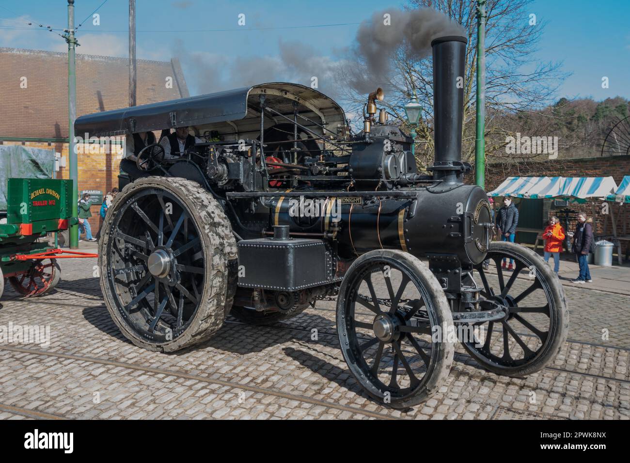 An old steam traction engine passing along a cobbled road. Pictured at ...