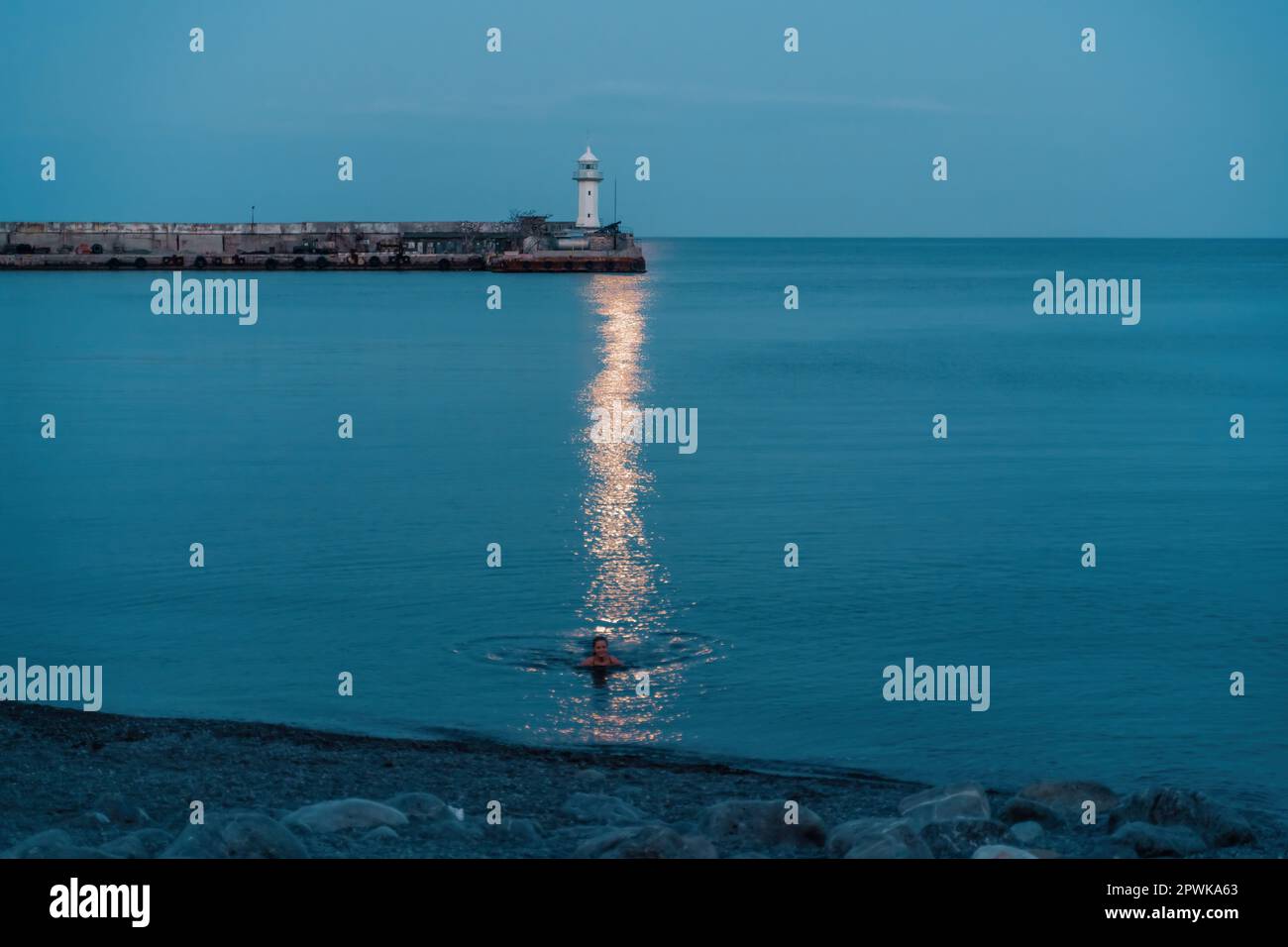 Woman The full moon rises to the lighthouse, the lunar path along the ...