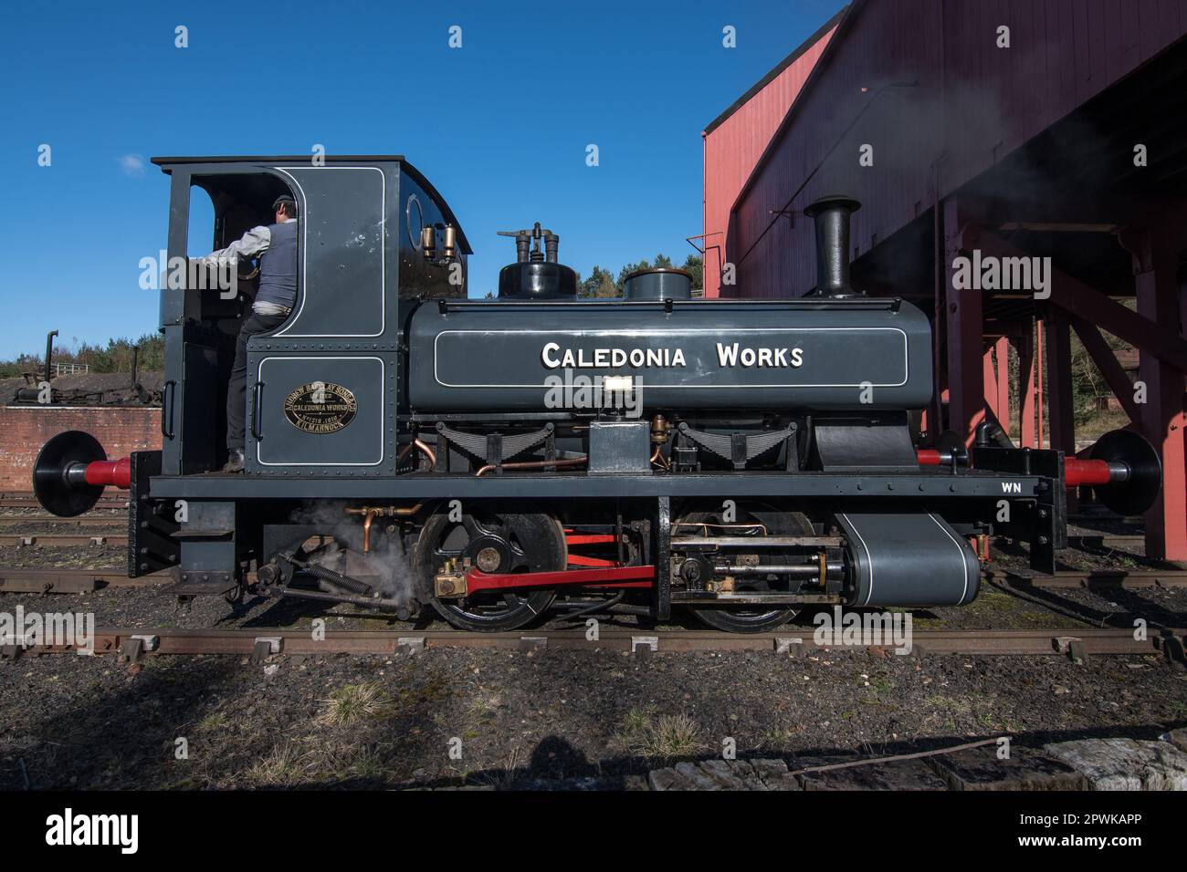 A beautifully restored steam tank engine amongst the surroundings of a ...